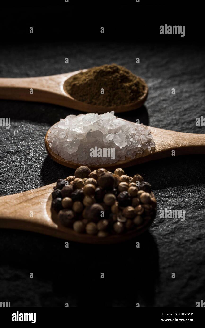 Wooden spoon with condiments Stock Photo - Alamy