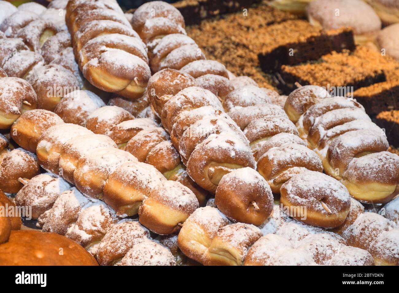 Display of traditional doughnuts on sale at Christmas market stall in ...