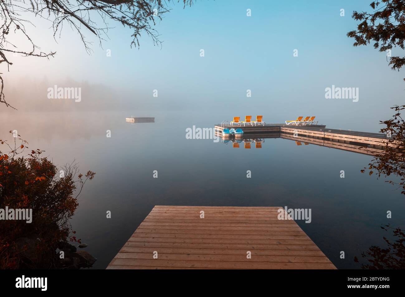 view of a boat dock the Lac-Superieur, misty morning with fog, in ...