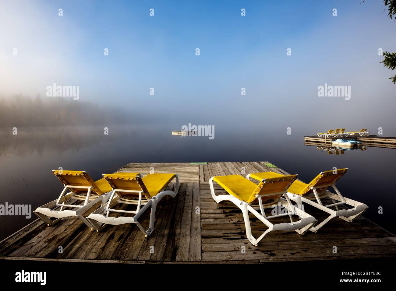 view of a boat dock the Lac-Superieur, misty morning with fog, in ...