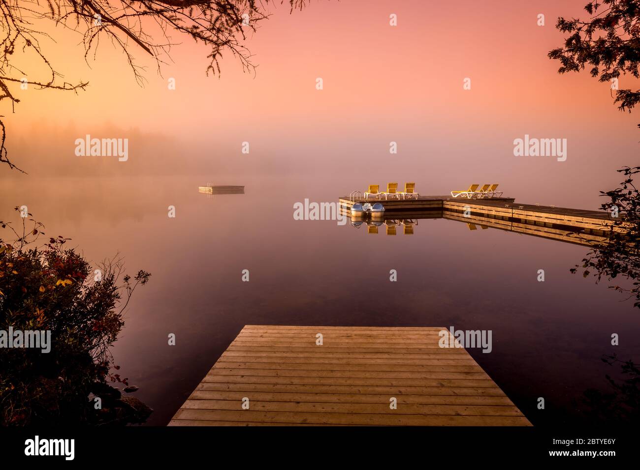view of a boat dock the Lac-Superieur, misty morning with fog, in ...