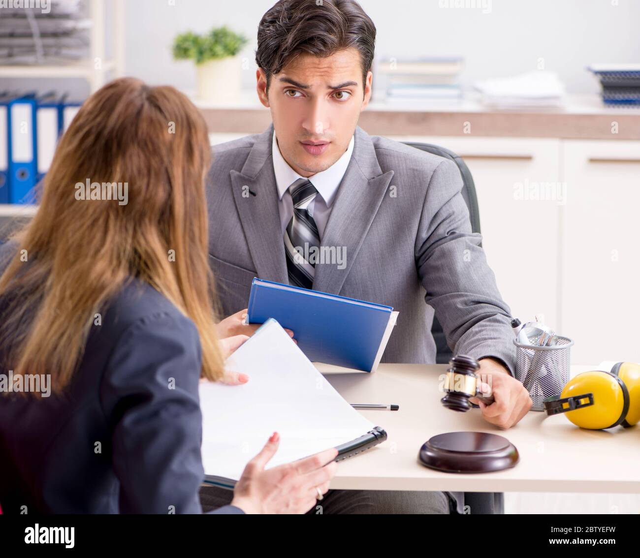 The lawyer talking to client in office Stock Photo - Alamy