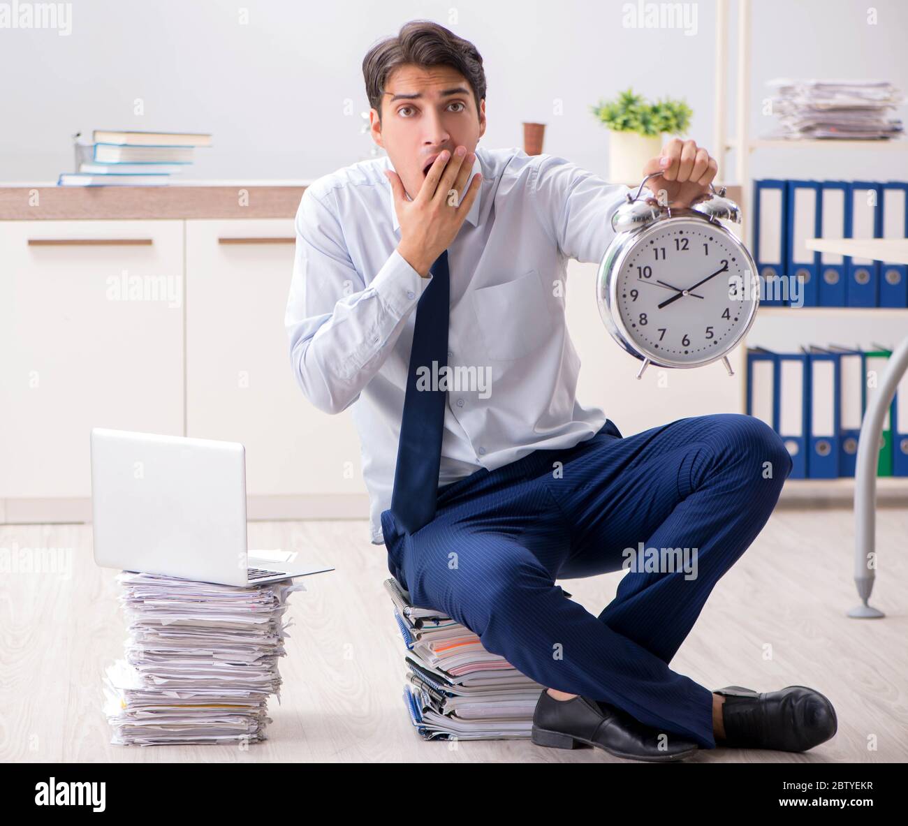 The extremely busy employee working in the office Stock Photo - Alamy