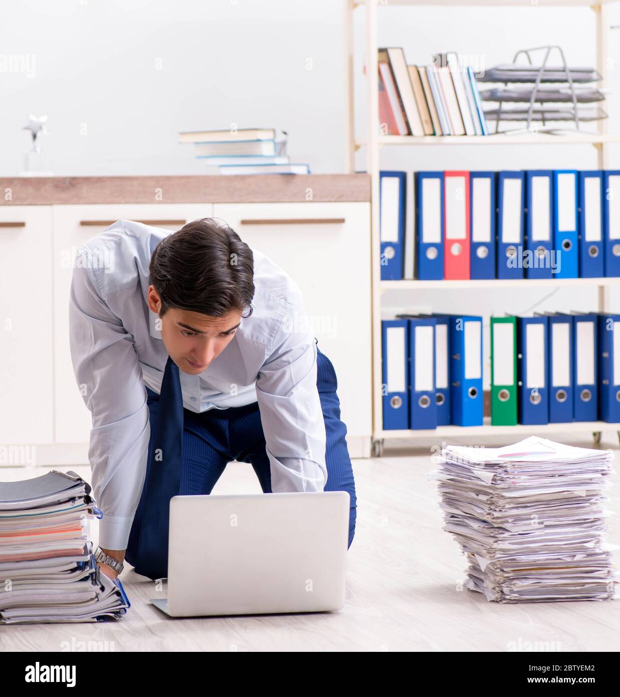 The extremely busy employee working in the office Stock Photo - Alamy
