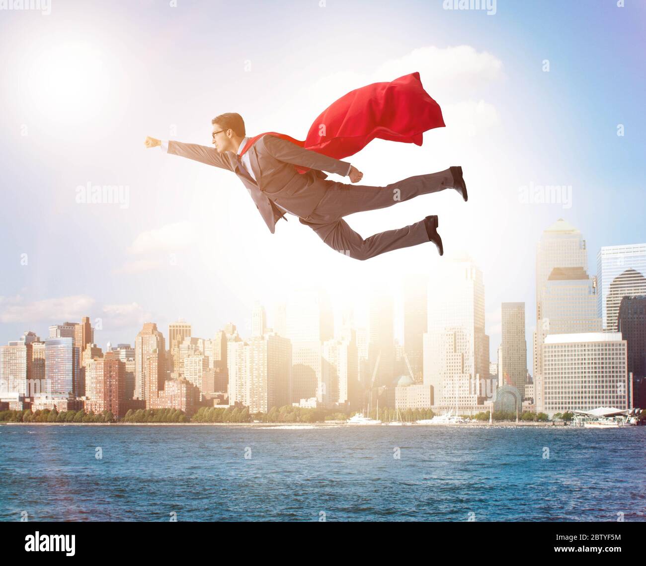 The superhero businessman flying over the city Stock Photo - Alamy