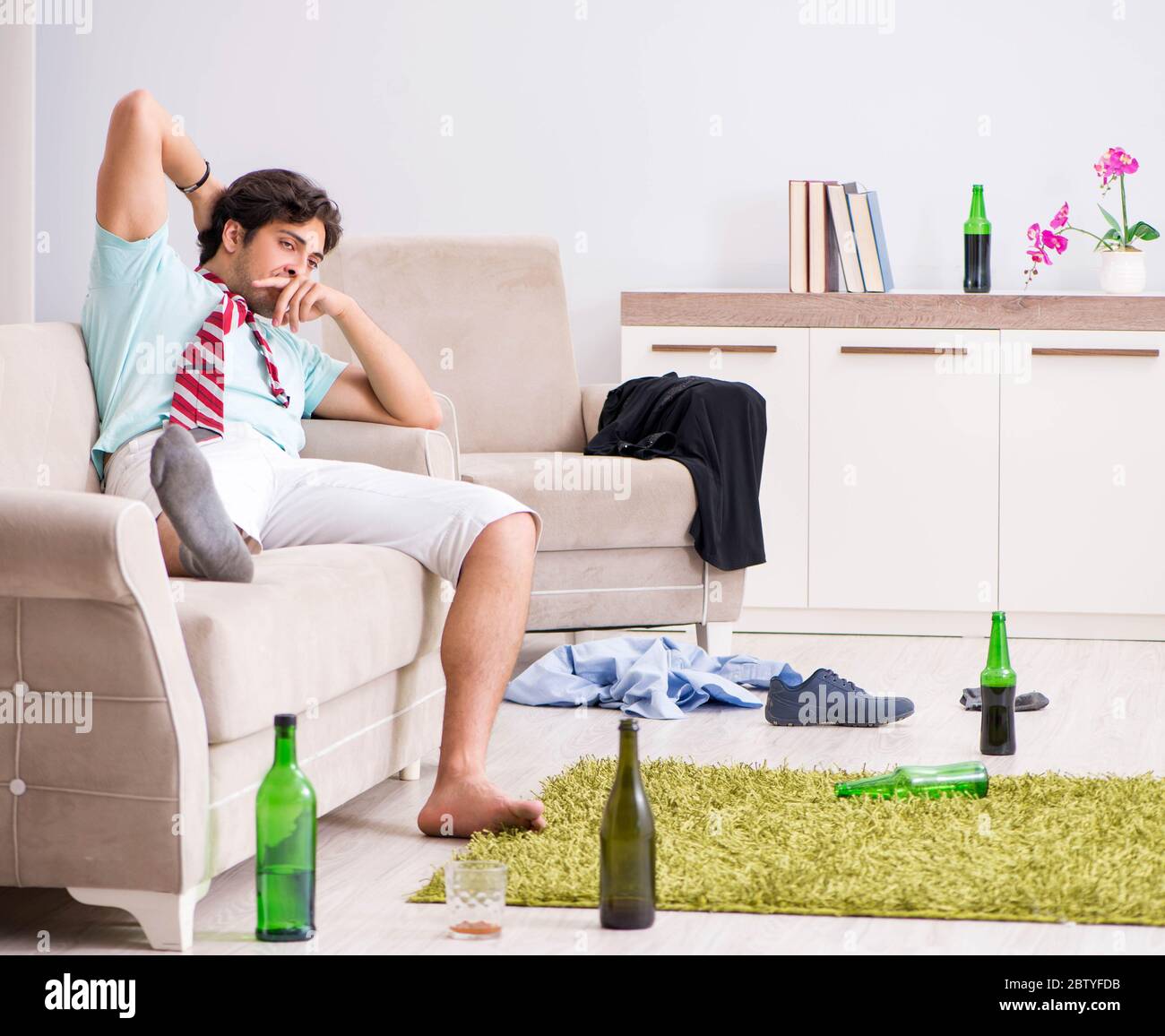 The young drunk handsome man after party at home Stock Photo - Alamy