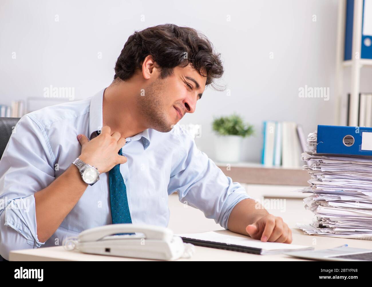 The overloaded busy employee with too much work and paperwork Stock ...