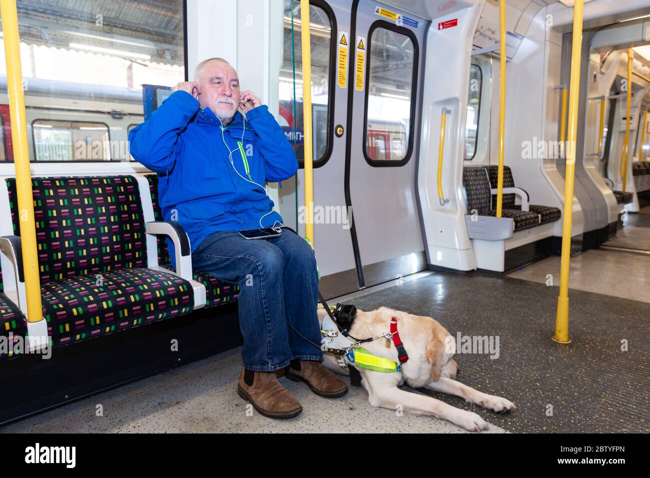 Guide Dog user commuting to work on the Underground Stock Photo - Alamy