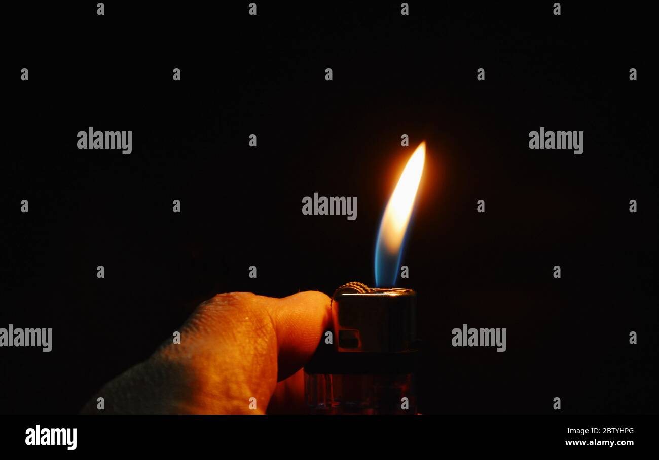 thumb lighting plastic lighter in dark Stock Photo - Alamy