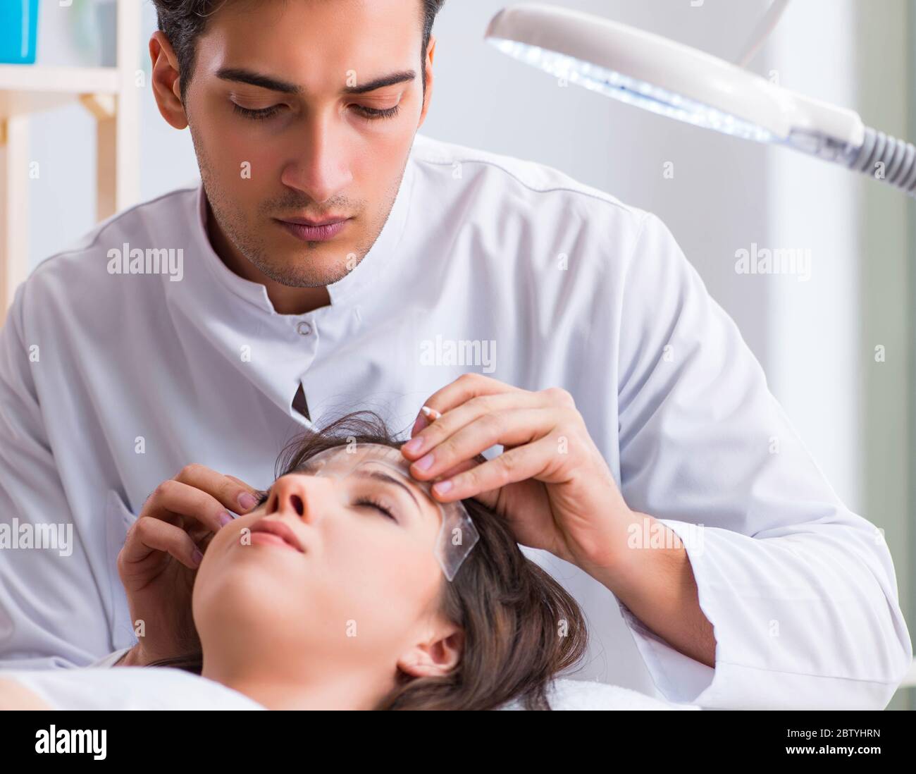 The doctor measuring patient's face before plastic surgery Stock Photo ...