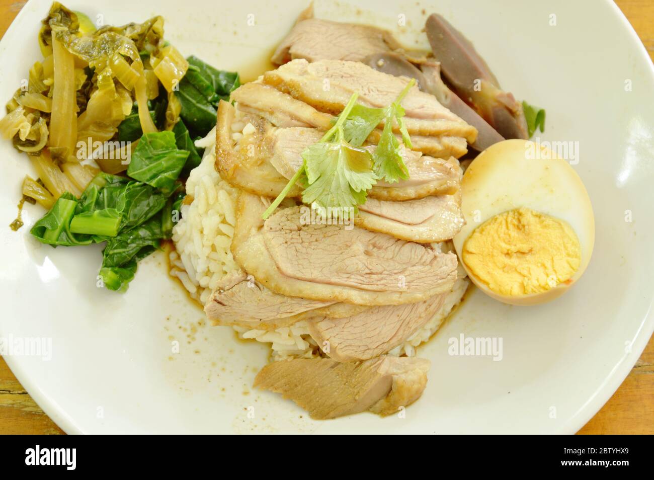 boiled duck meat slice dressing brown sauce with egg on rice Stock ...
