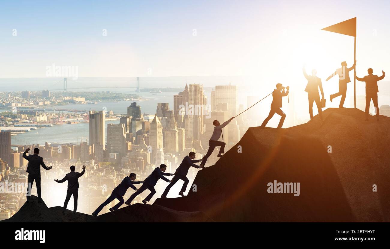 Concept of teamwork with team climbing mountain Stock Photo - Alamy
