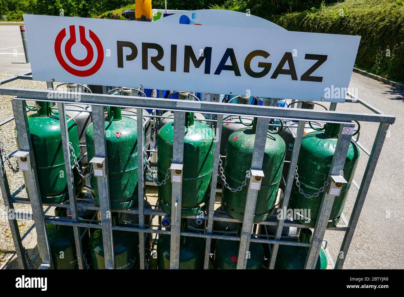 Bottled gas cylinders in rack, outside a supermarket in the Ariege ...