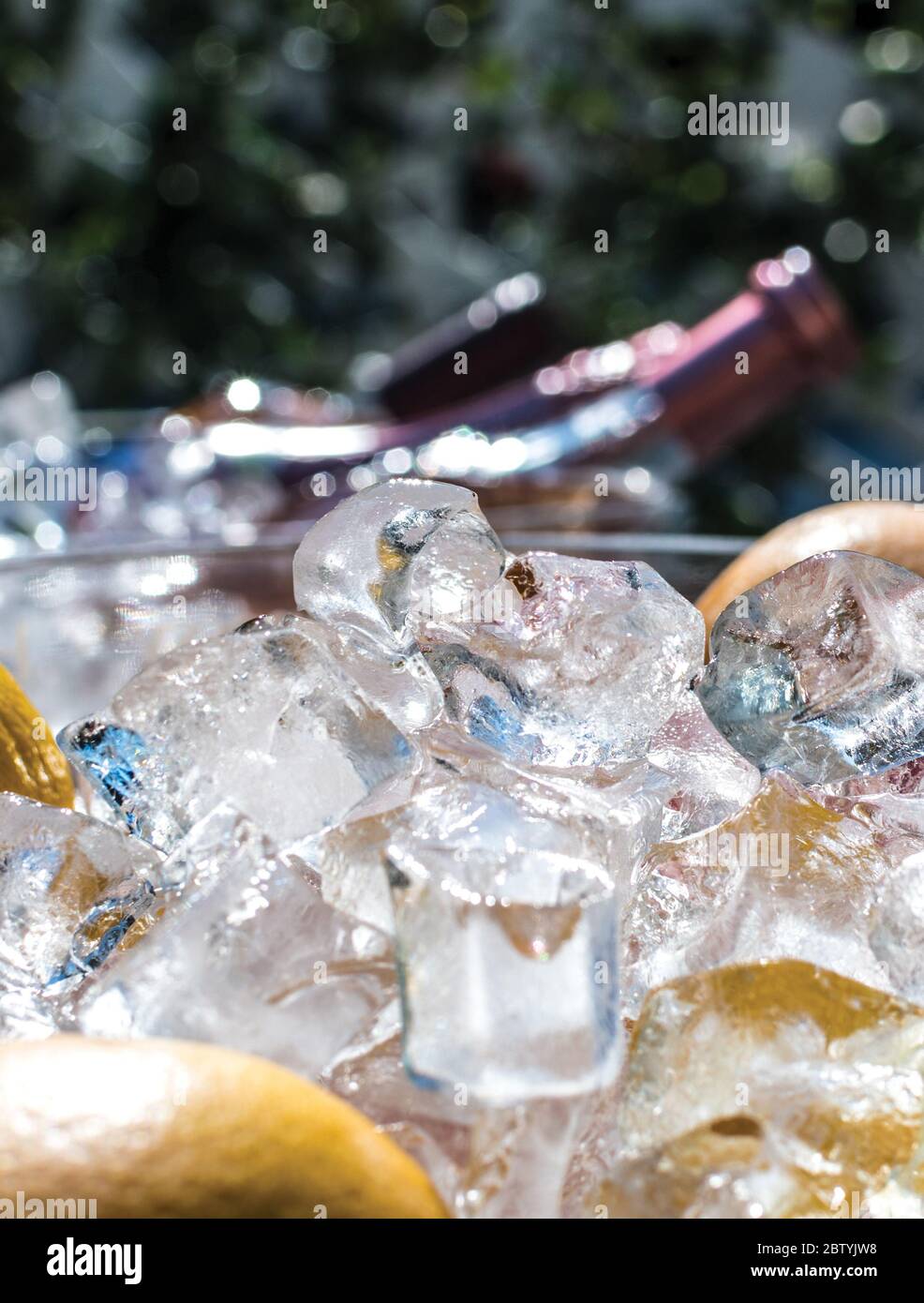 Ice cubes in ice bucket over alcoholic and non alcoholic cold drinks ...