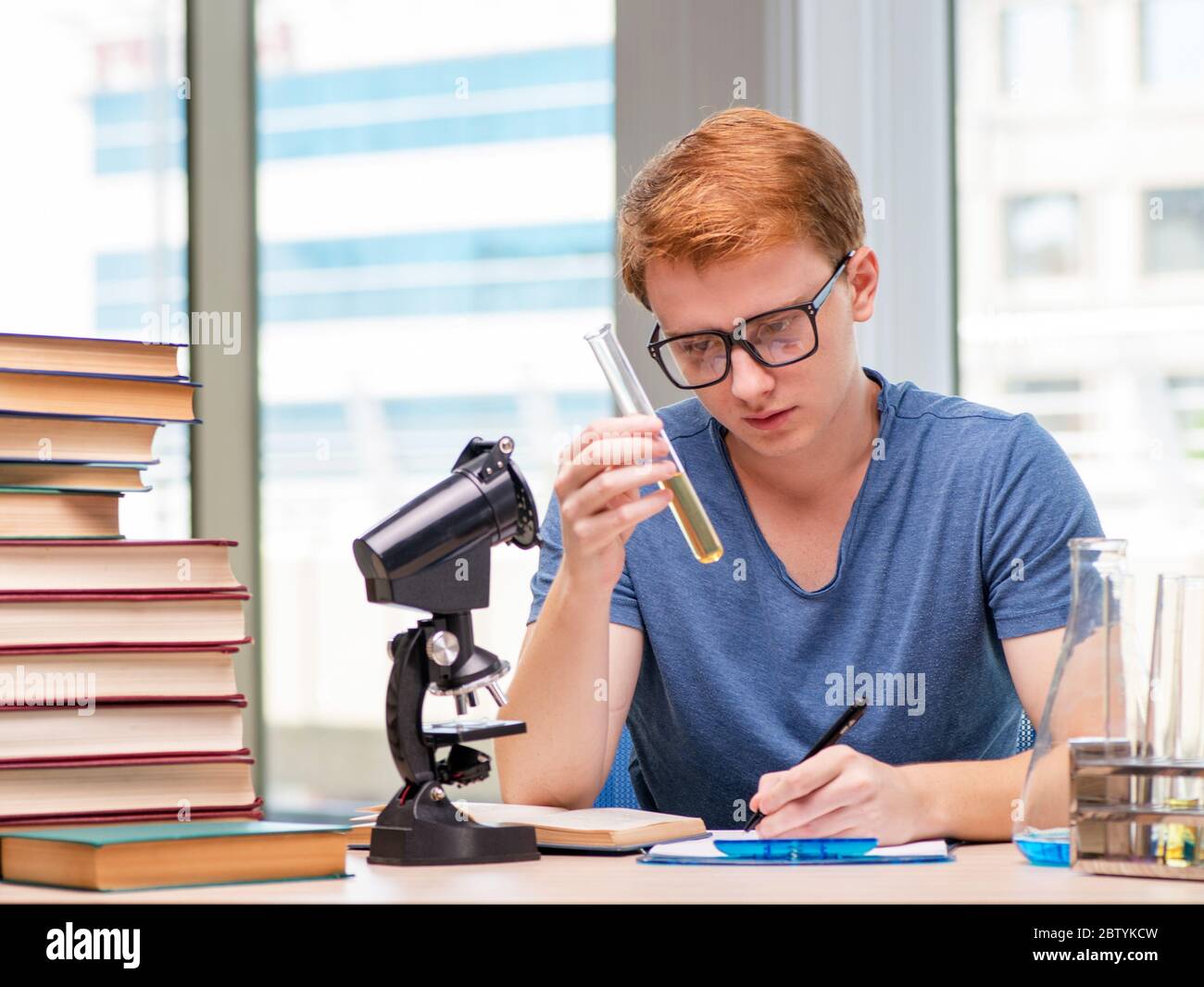 Young student tired and exhausted preparing for exam Stock Photo - Alamy