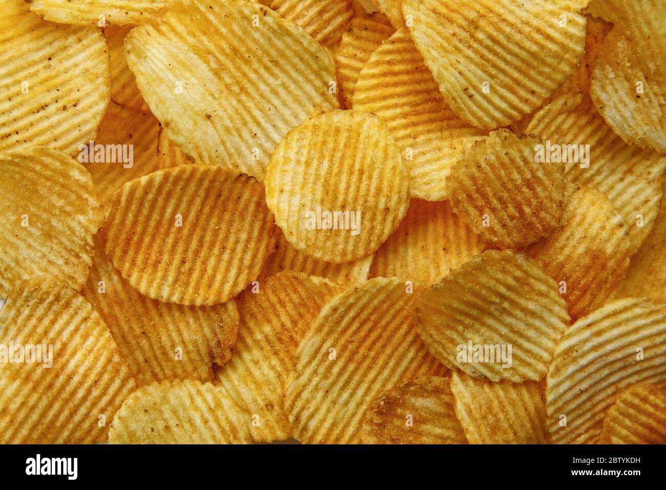Corrugated Potato Chips. Food background. Top view Stock Photo - Alamy