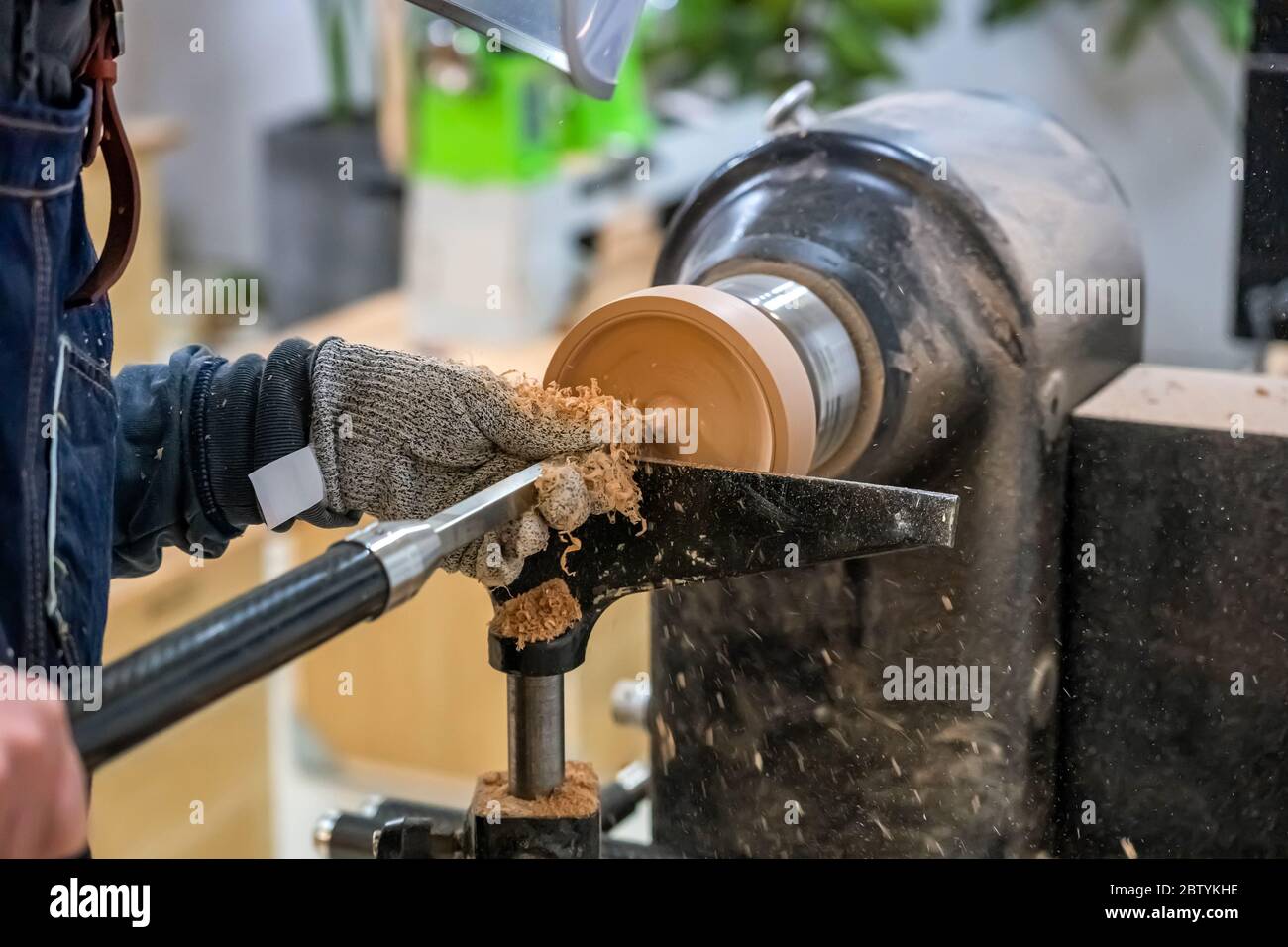Carpenter man is shaving the wooden bowl. Spinning wood wheel. Carving ...