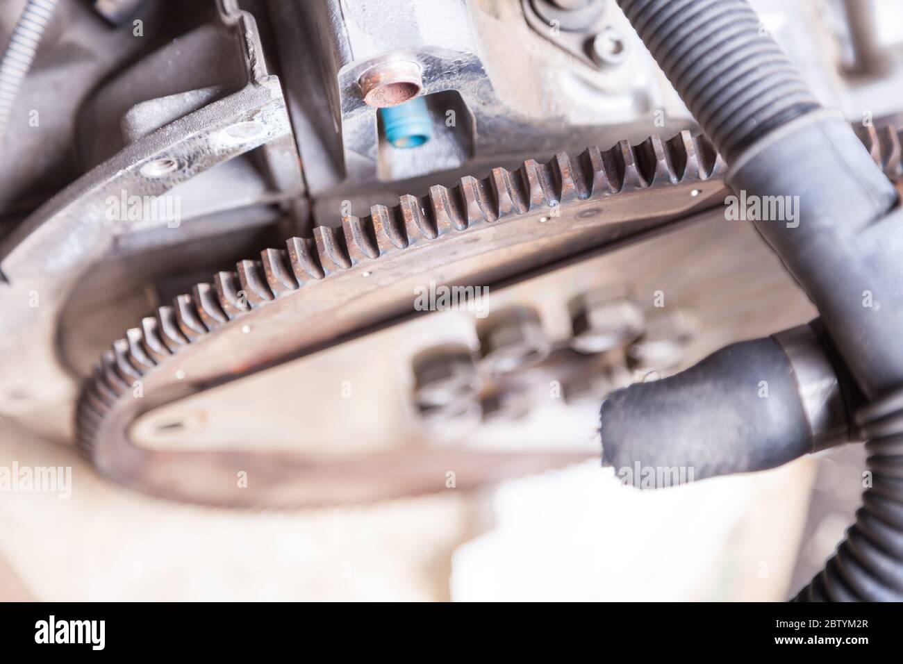 Closeup of a metal gear disk on an engine with a set of teeths shot in ...