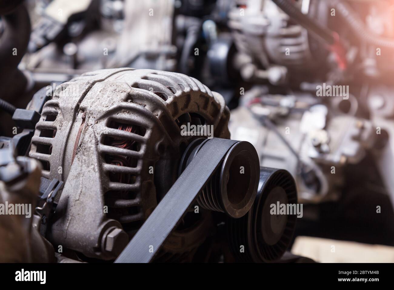Close-up of the generator on an engine with a bypass belt is a part in ...