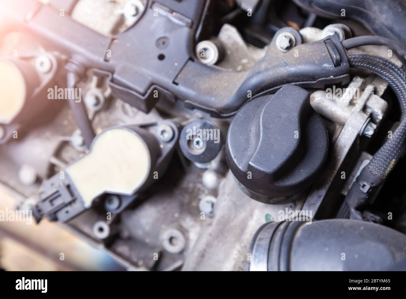 Closeup of an engine cover for pouring black oil against the background ...