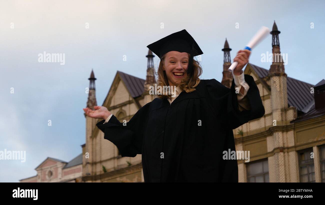Happy graduate student holding a diploma smiling to camera Stock Photo ...