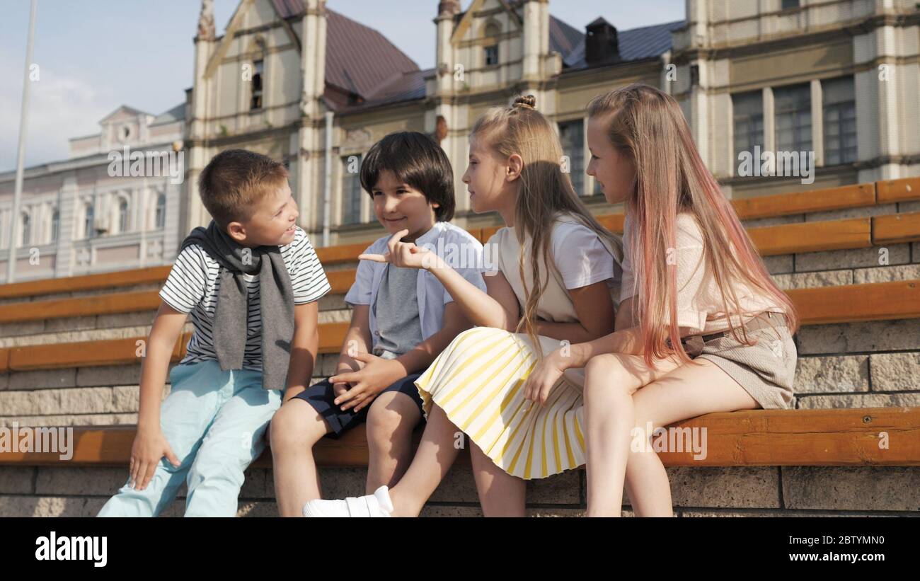 Four girls sitting on the bench hi-res stock photography and images - Alamy