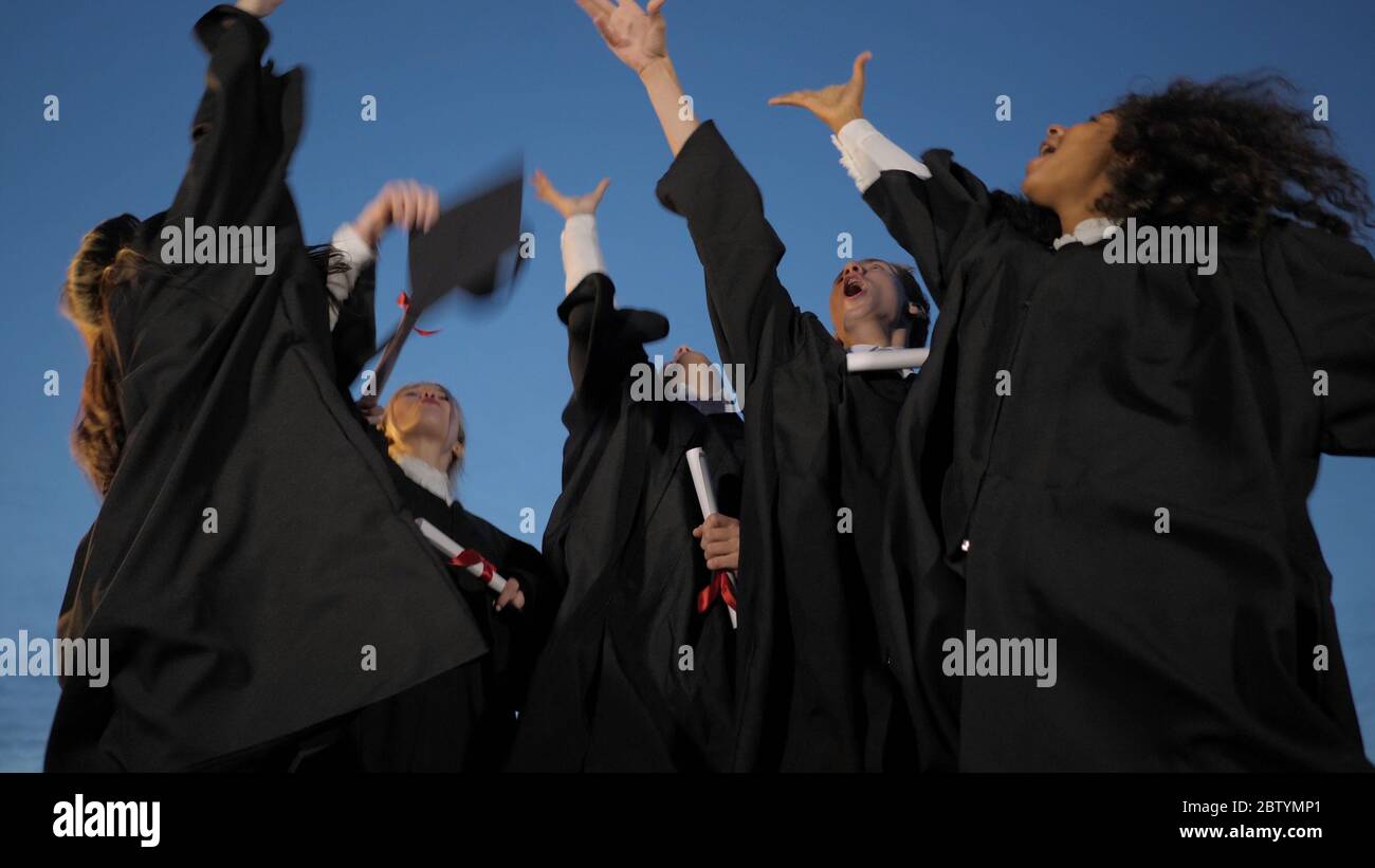 Happy and excited group of student friends on graduation day thr Stock ...