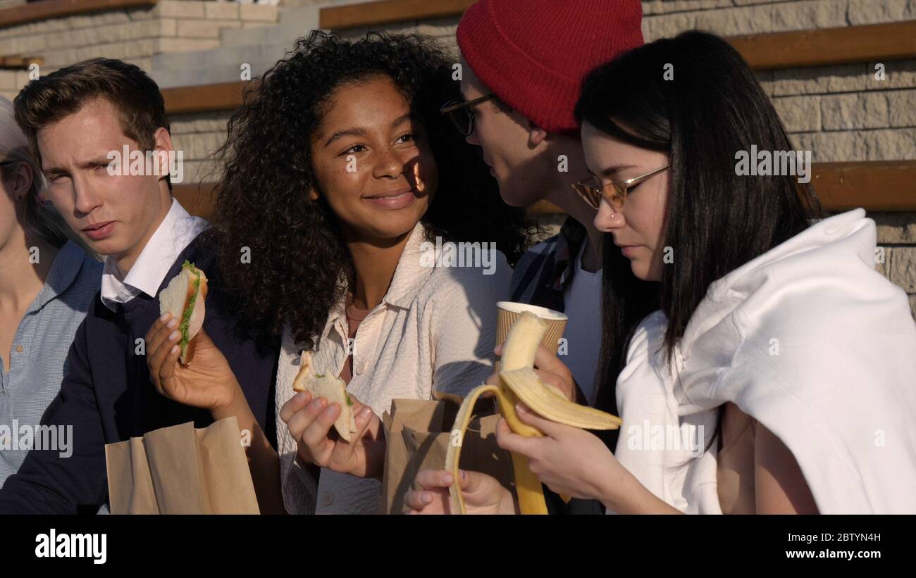 Friends students eating and having fun Stock Photo - Alamy