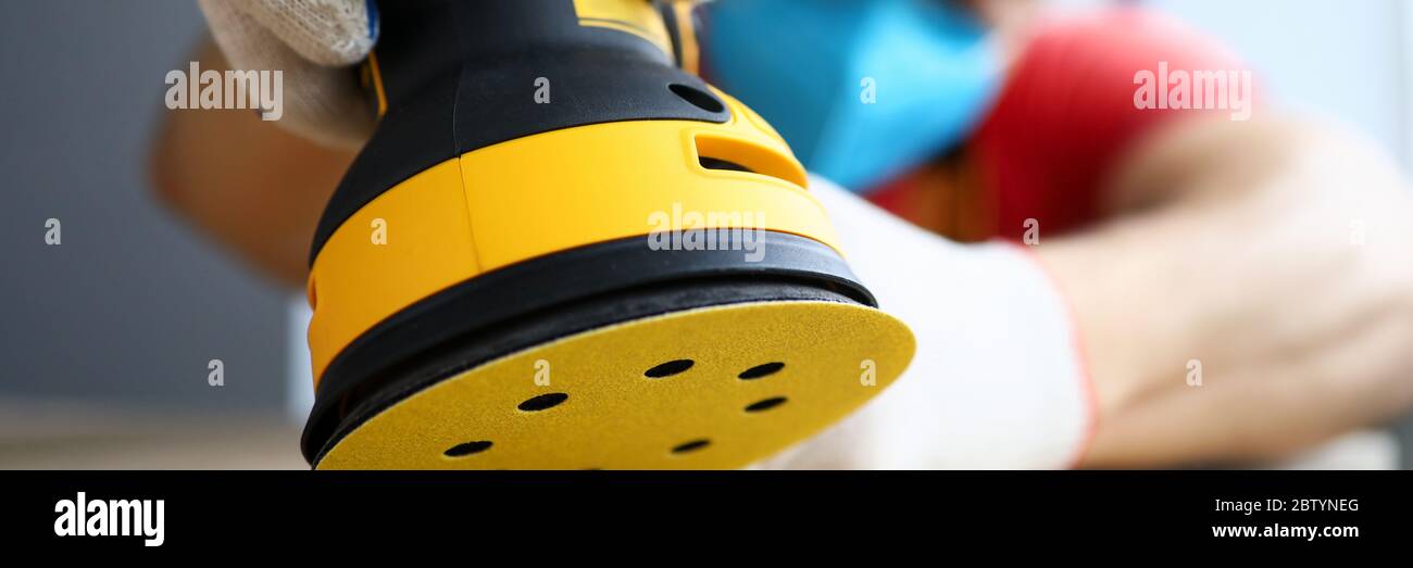 Professional carpenter using sander Stock Photo - Alamy