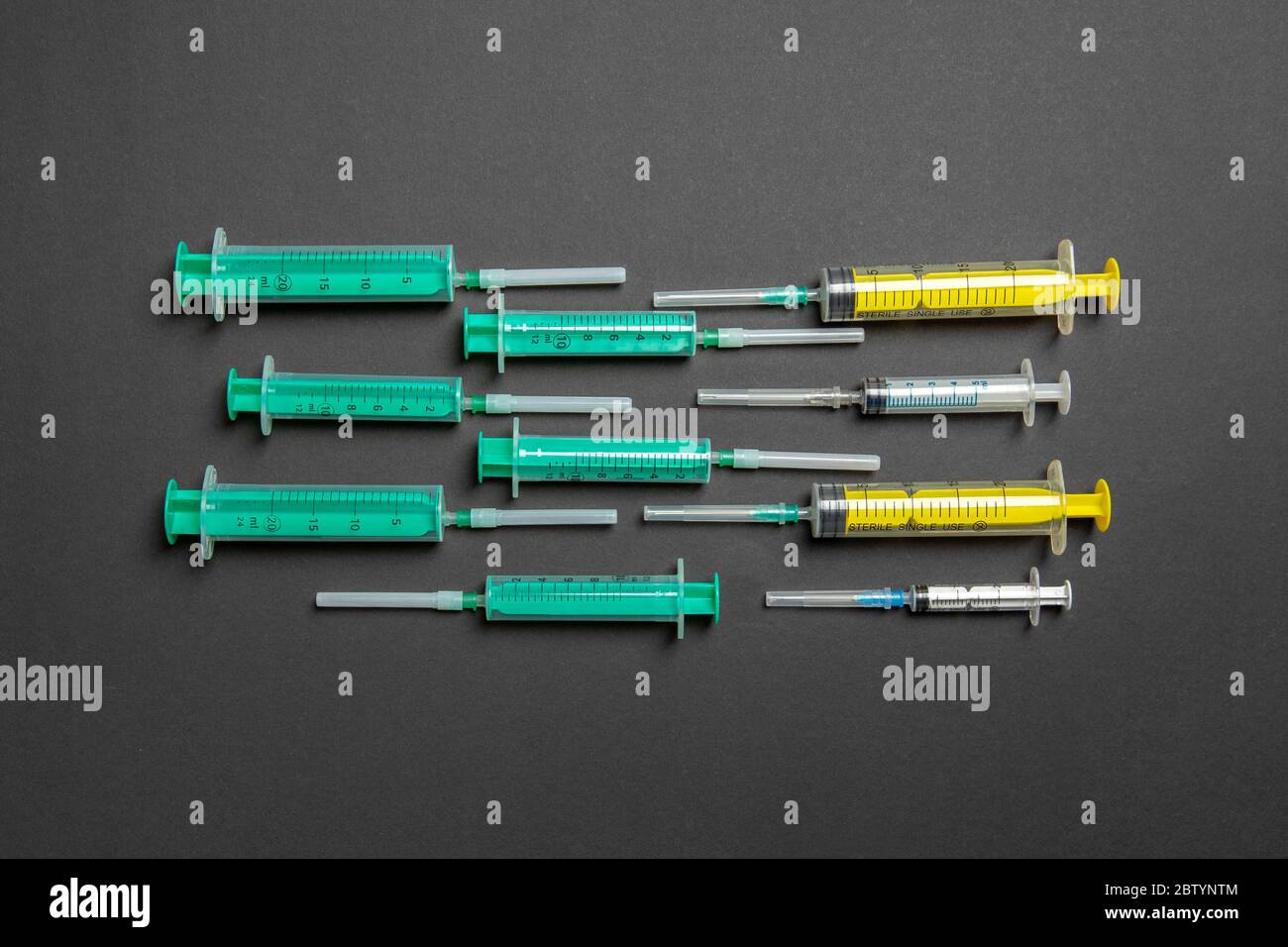 Top view of different syringes at black background. Medical injection ...
