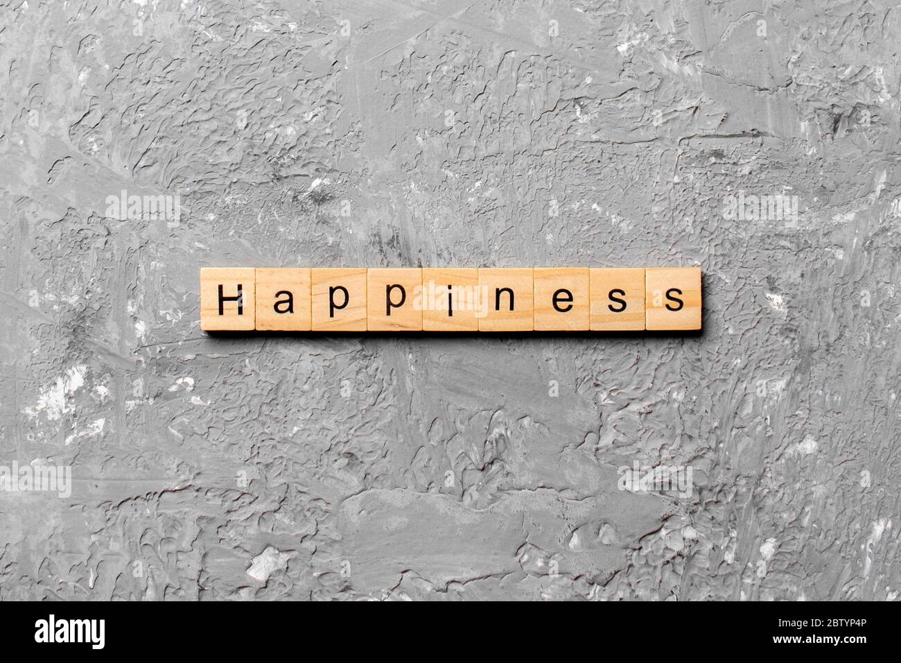 Happiness word written on wood block. Happiness text on table, concept ...