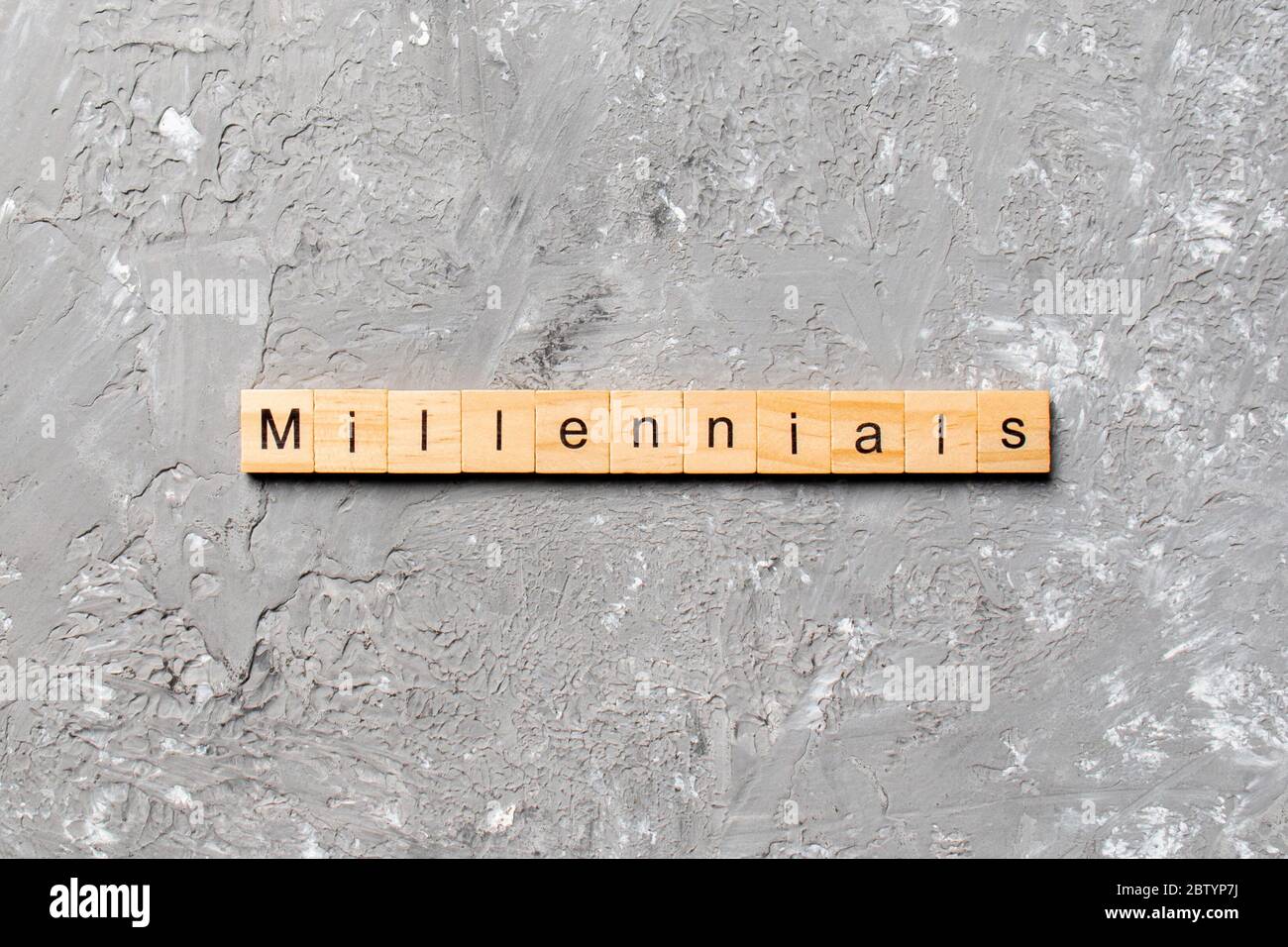 millennials word written on wood block. millennials text on table ...