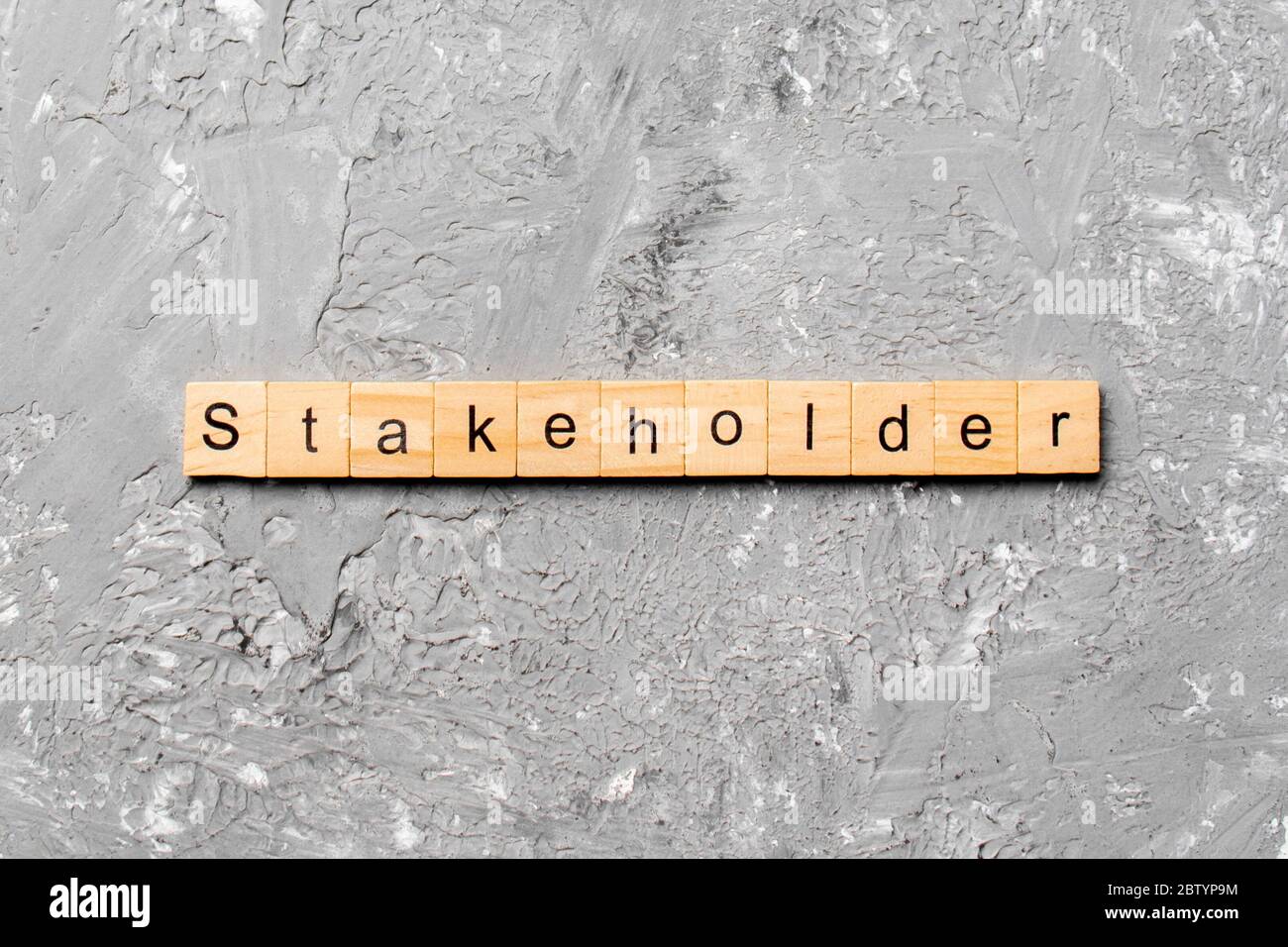 Stakeholder word written on wood block. Stakeholder text on cement ...