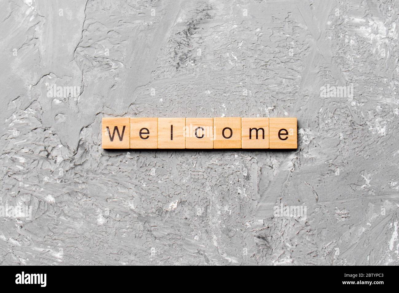 WELCOME word written on wood block. WELCOME text on table, concept ...