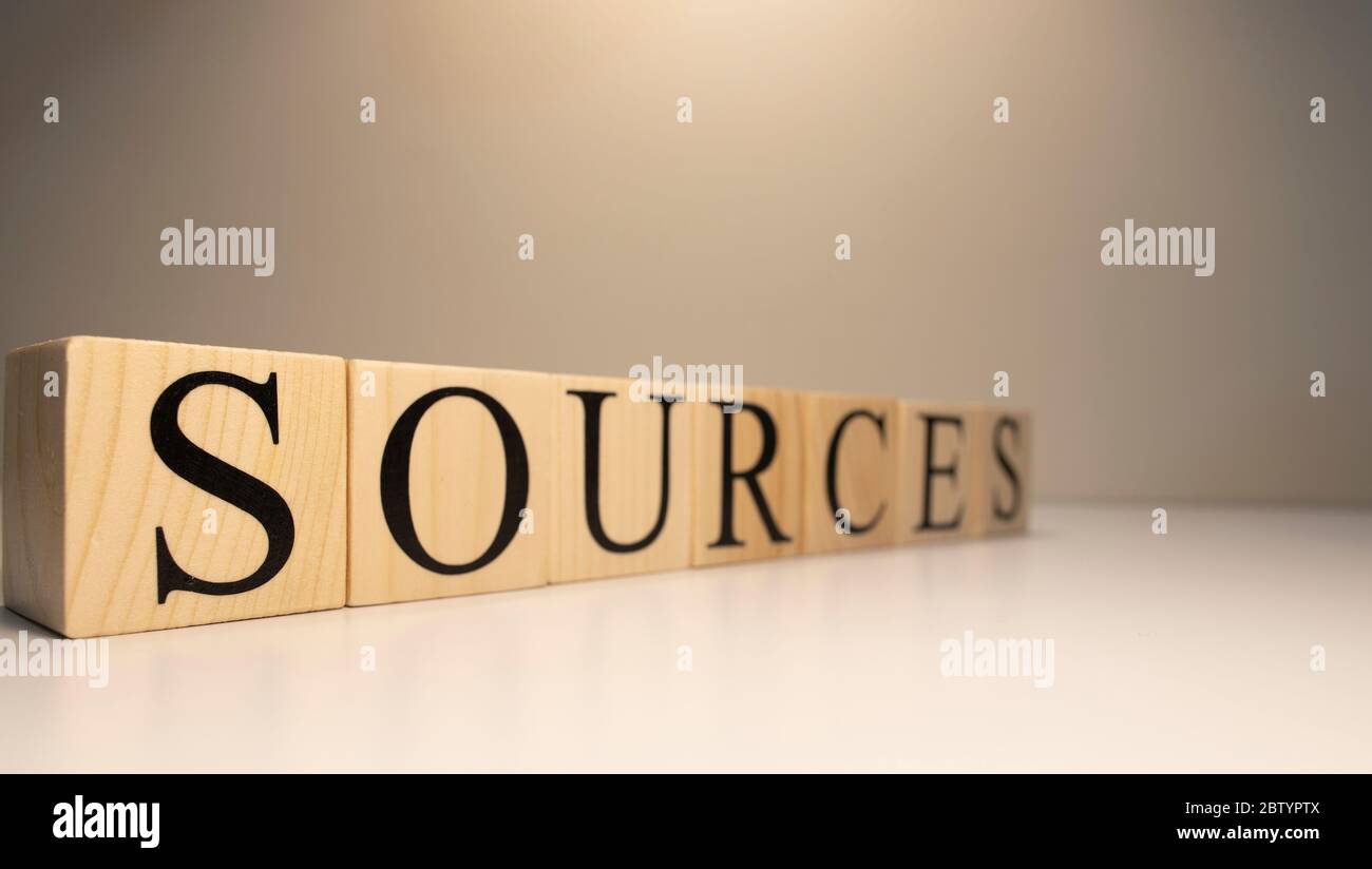 Sources text from wooden cubes. On a white background. Close up Stock ...