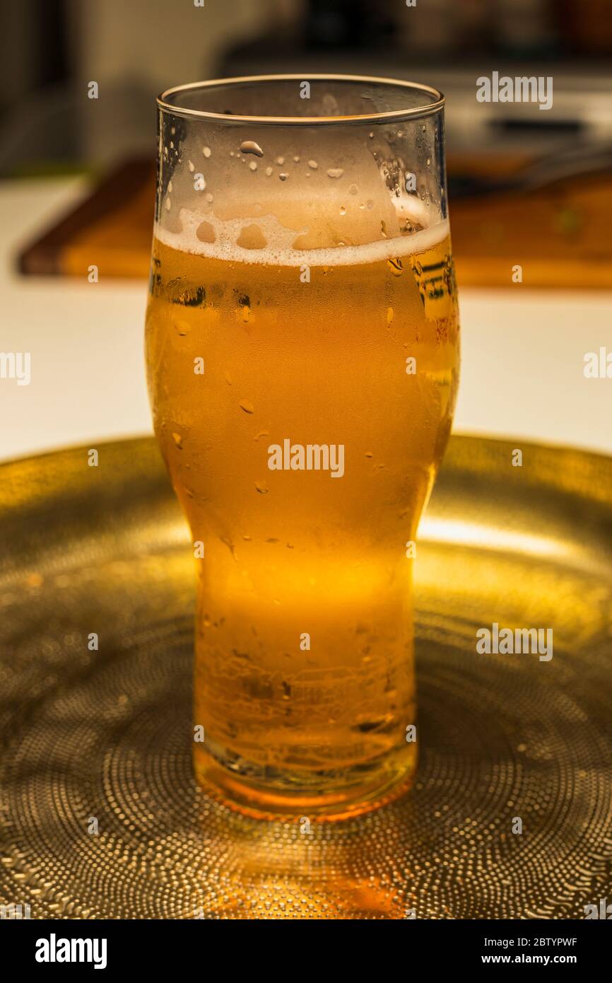 beer on bar table on blur background Stock Photo - Alamy