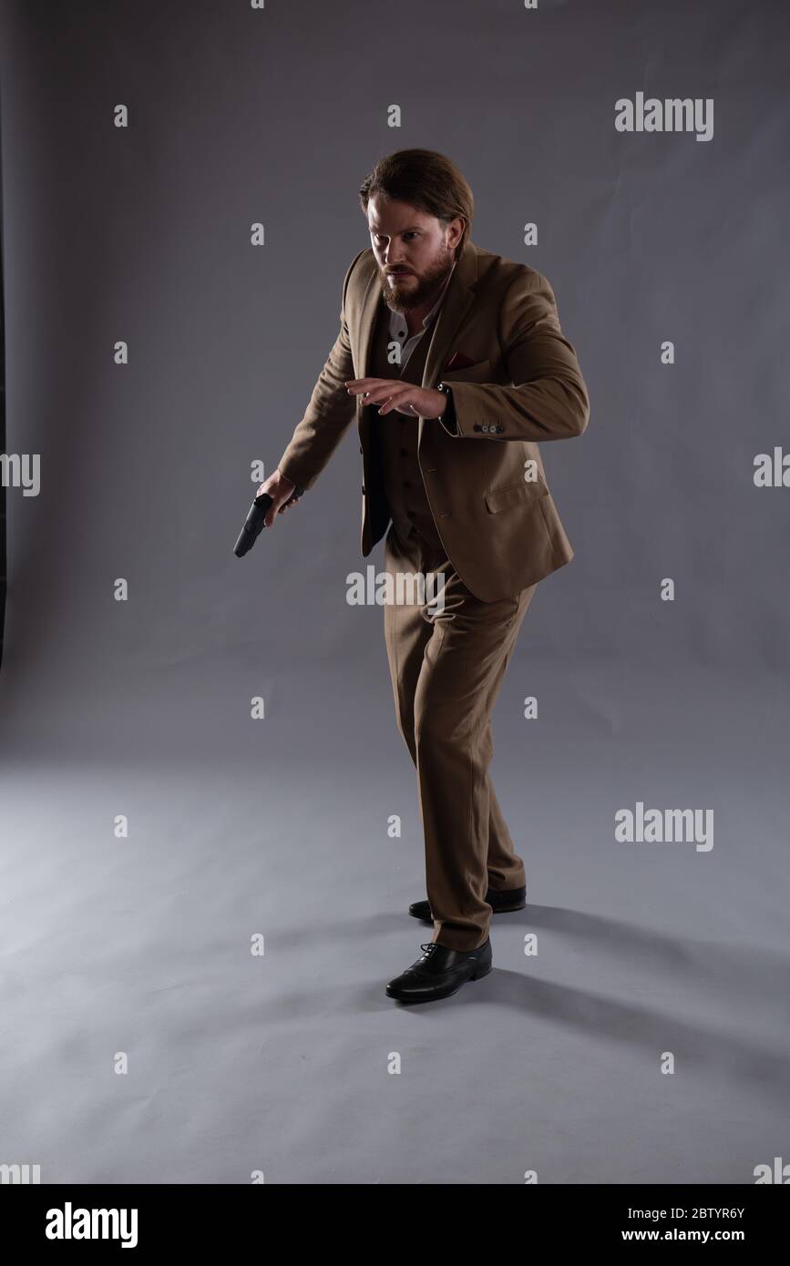 Image of man holding gun hi-res stock photography and images - Alamy