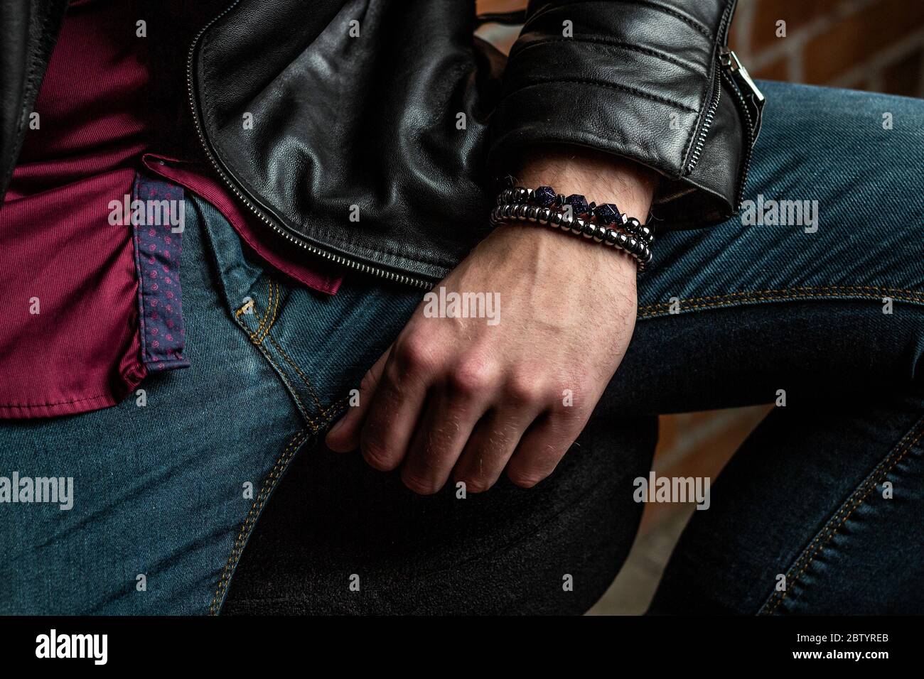 Men's bracelet amulet made of agate stone, on a hand in a leather ...