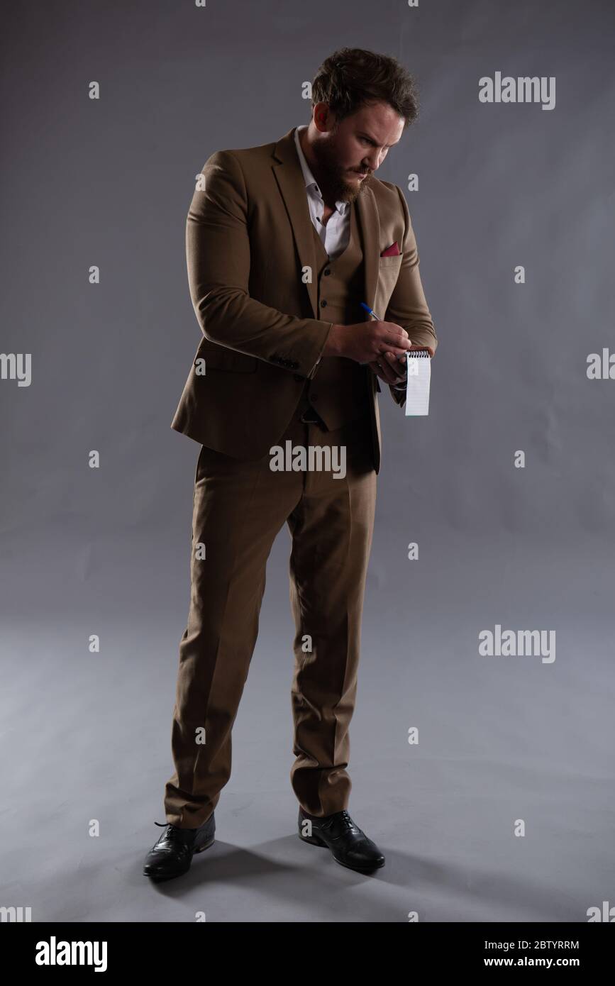 Isolated image of an undercover cop with a gun against a plain ...