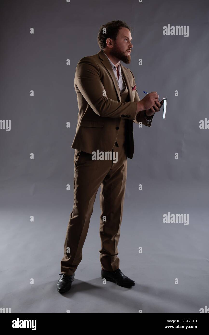 Isolated image of an undercover cop with a gun against a plain ...