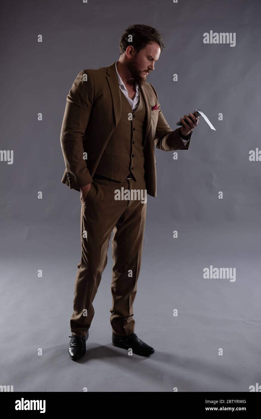 Isolated image of an undercover cop with a gun against a plain ...