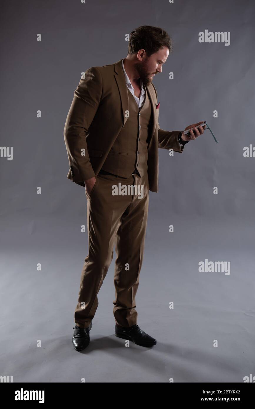 Isolated image of an undercover cop with a gun against a plain ...