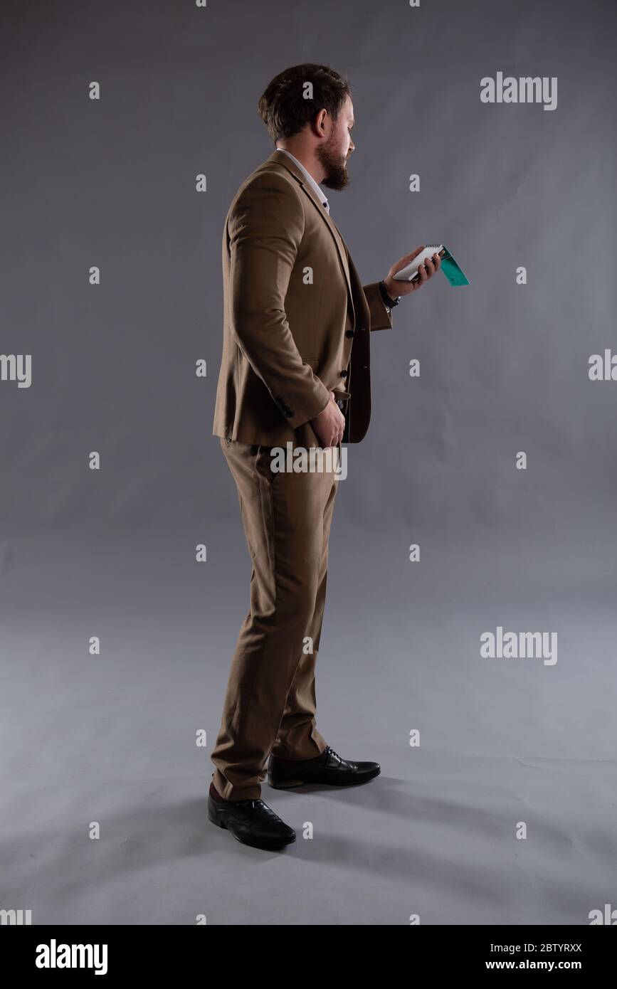 Isolated image of an undercover cop with a gun against a plain ...