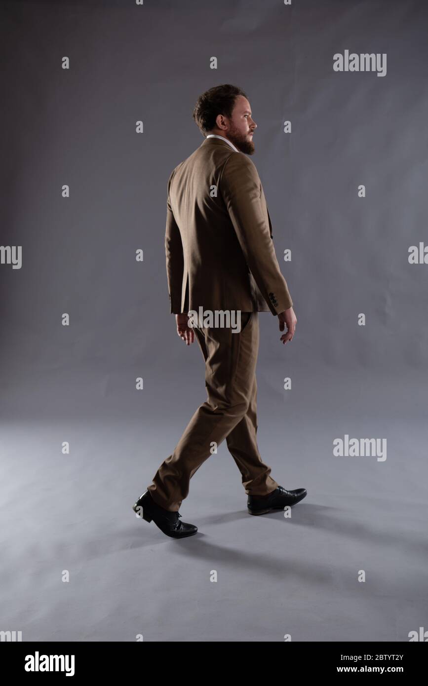 Isolated image of an undercover cop with a gun against a plain ...