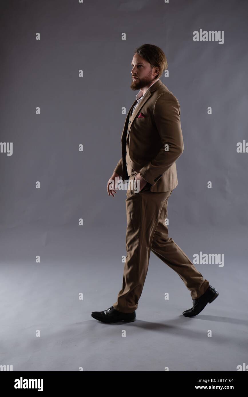 Isolated image of an undercover cop with a gun against a plain ...