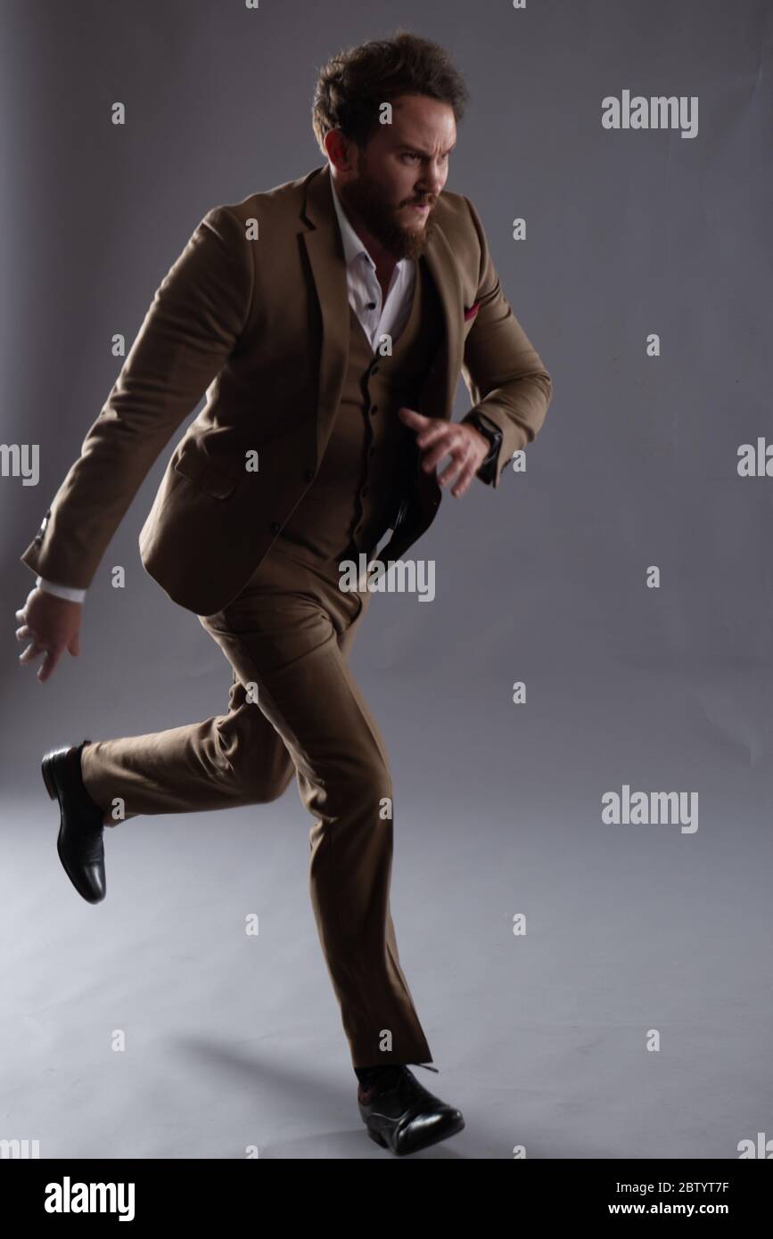 Isolated image of an undercover cop with a gun against a plain ...