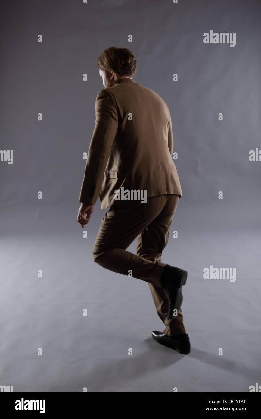 Man running suit gun hi-res stock photography and images - Alamy