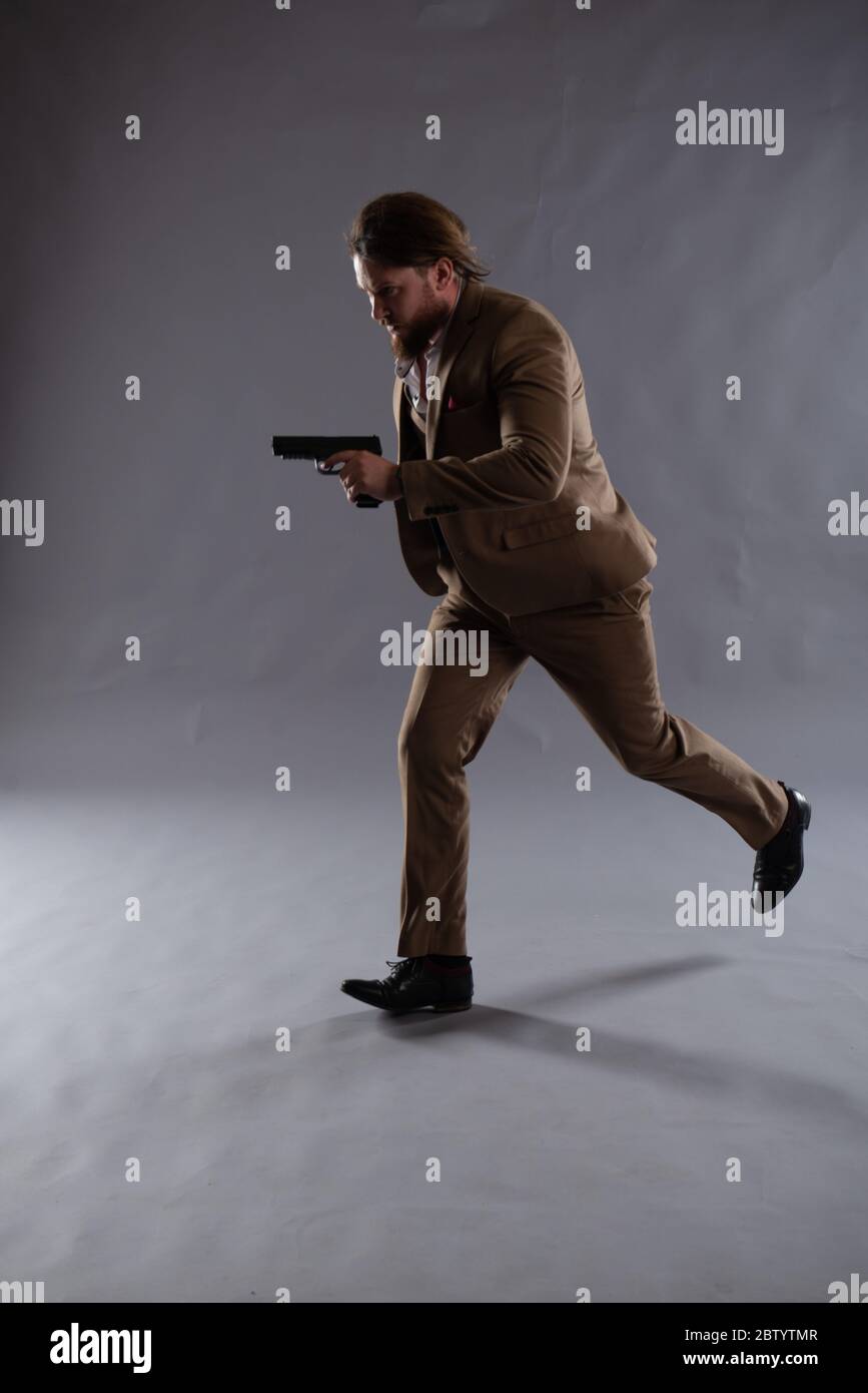 Man with gun running hi-res stock photography and images - Alamy
