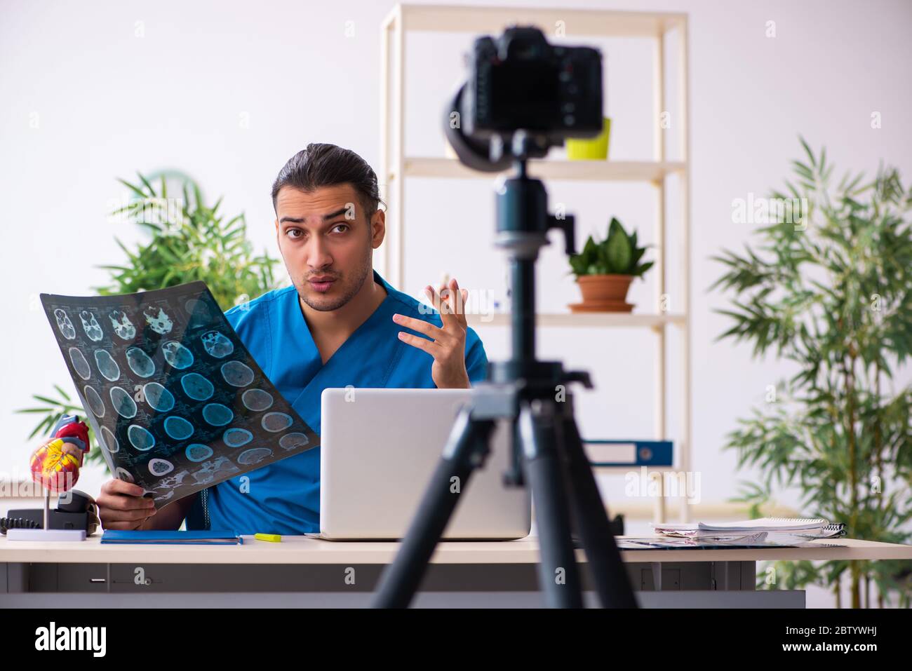 Young doctor recording video for his blog Stock Photo - Alamy