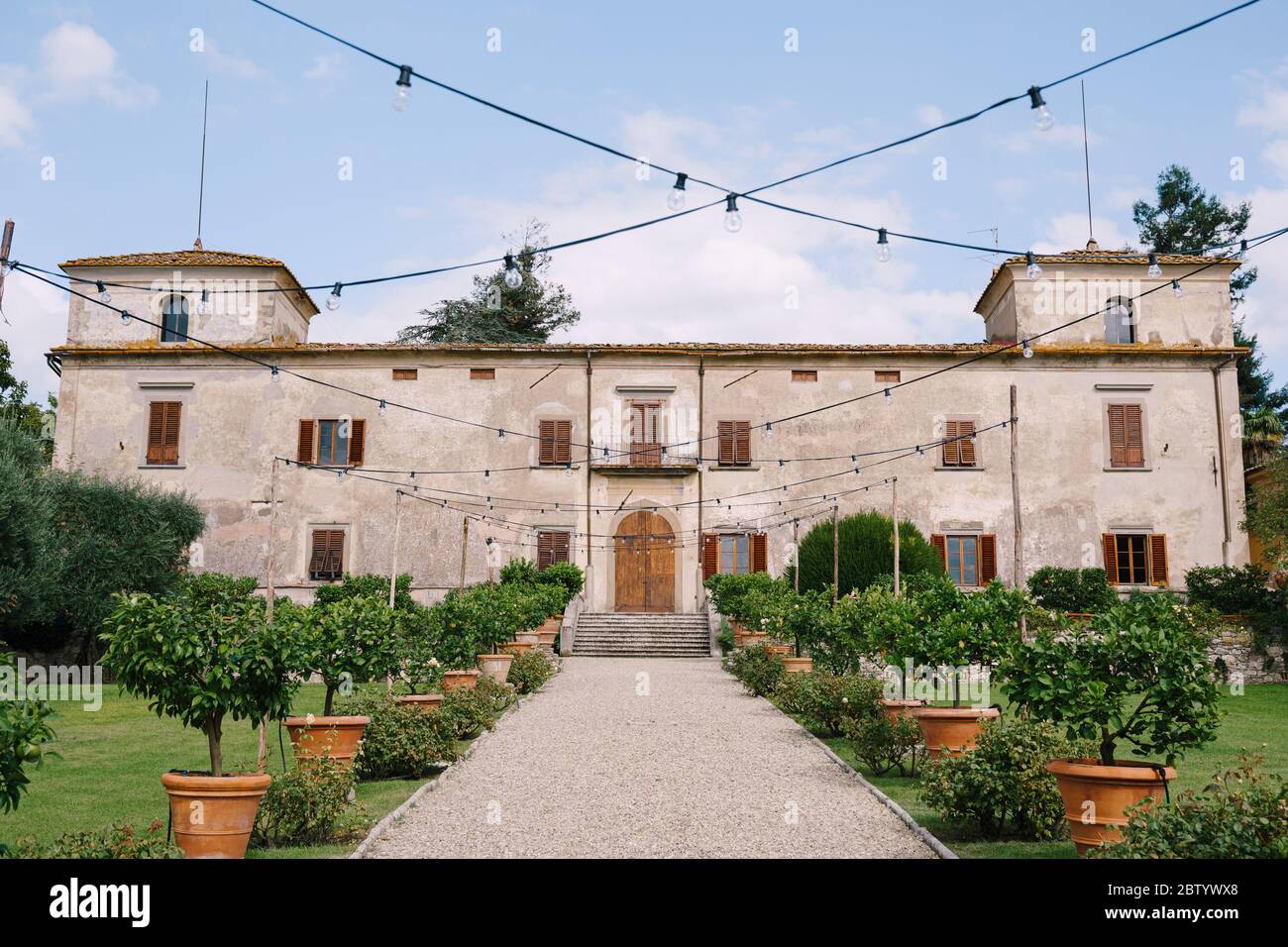 Facade of an old Italian villa. Garden and territory of a winery in ...